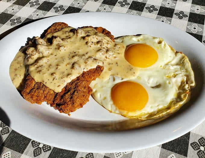 Country fried steak smothered in gravy with sunny-side-up eggs &ndash; breakfast that doubles as armor against whatever the day throws at you.