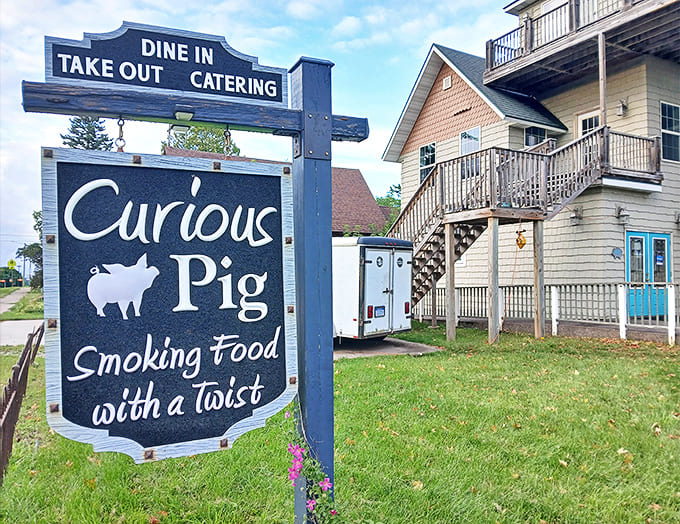The Curious Pig's sign promises smoked food with personality, delivering flavors that make your taste buds stand up and applaud.