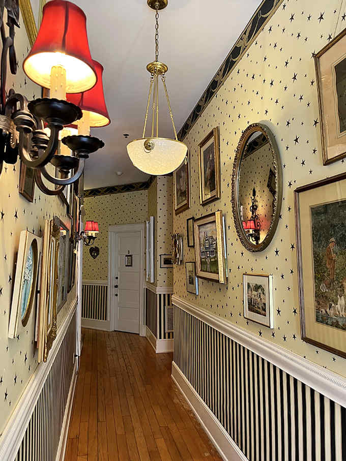 Every inch tells a story in this corridor where wallpaper patterns and vintage frames create a gallery of Victorian aesthetics.