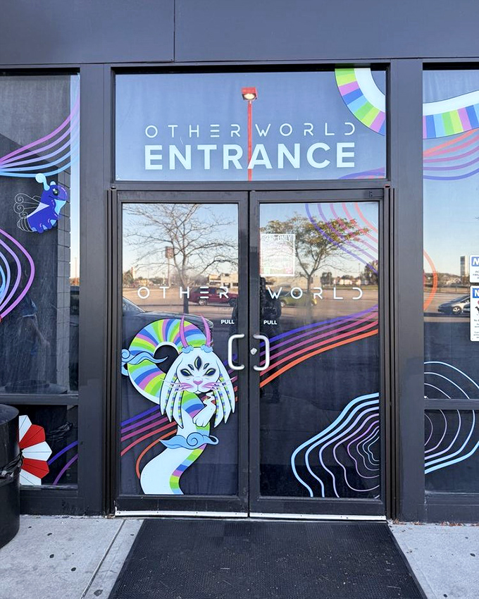 The official entrance beckons with colorful creatures and swirling patterns &ndash; your first hint of the madness within.