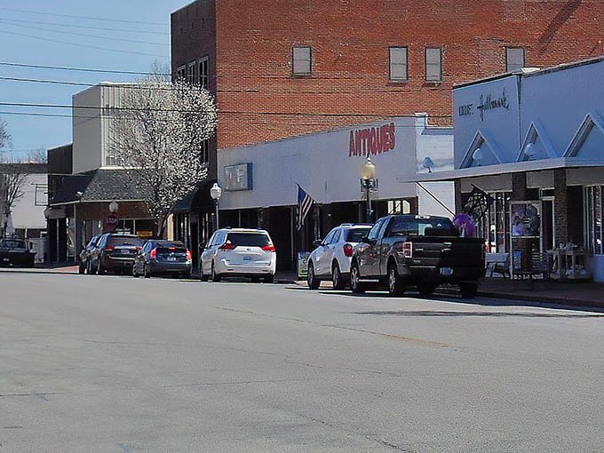 Downtown storefronts maintain their mid-century charm, inviting treasure hunters to discover antiques and collectibles within.