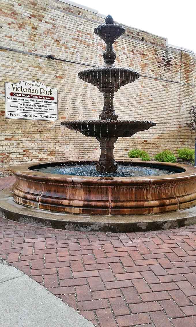 The classic fountain creates a peaceful soundtrack for afternoon strolls, benches inviting visitors to sit and watch life unfold.