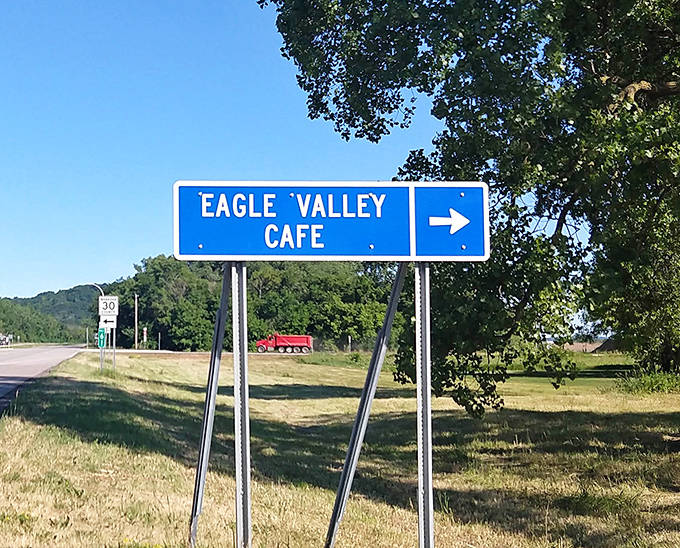 The blue highway sign points the way to culinary salvation, a breadcrumb trail leading hungry travelers to one of Wabasha's best-kept secrets.
