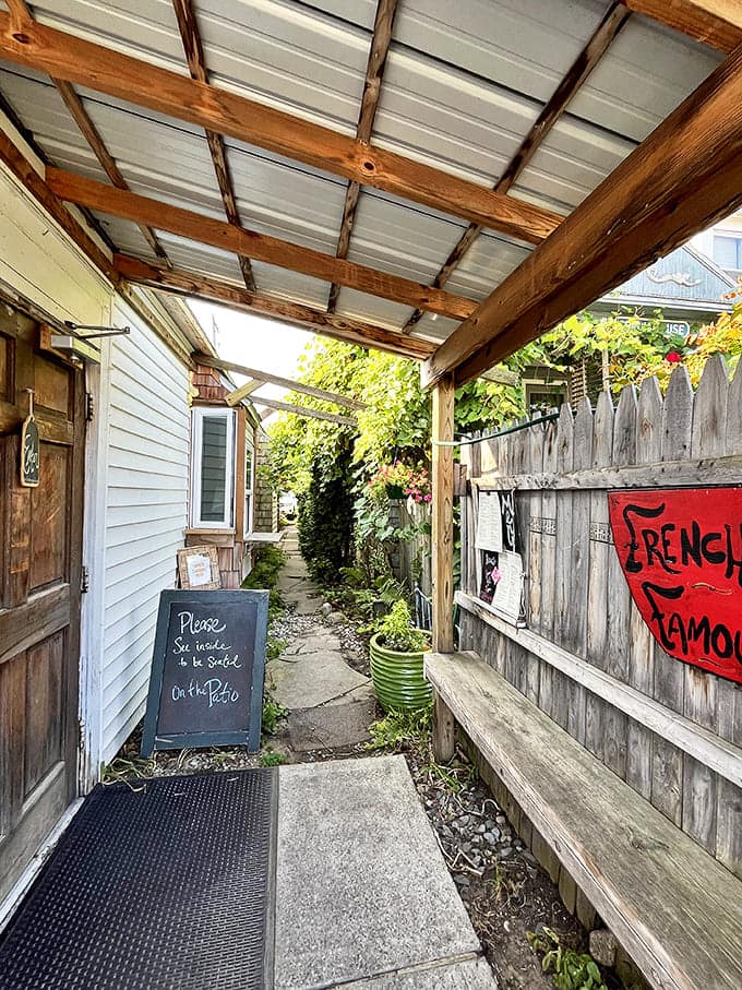 The entrance pathway feels like discovering a hidden treasure – a culinary speakeasy where the password is simply "hungry."