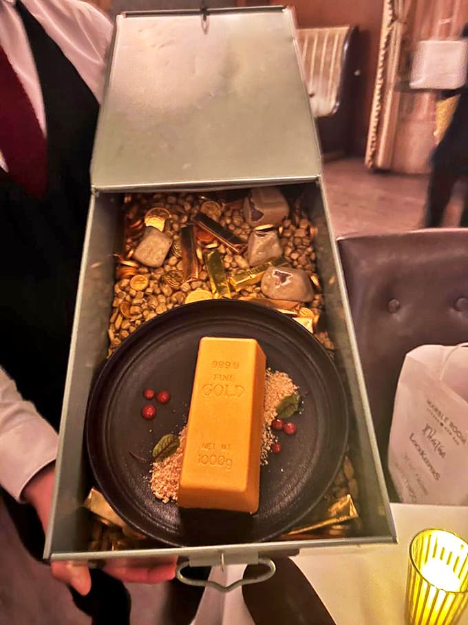 The "Gold Bar" dessert arrives like a sweet bullion from Fort Knox &ndash; edible luxury that makes you feel like you've robbed the very bank you're dining in.
