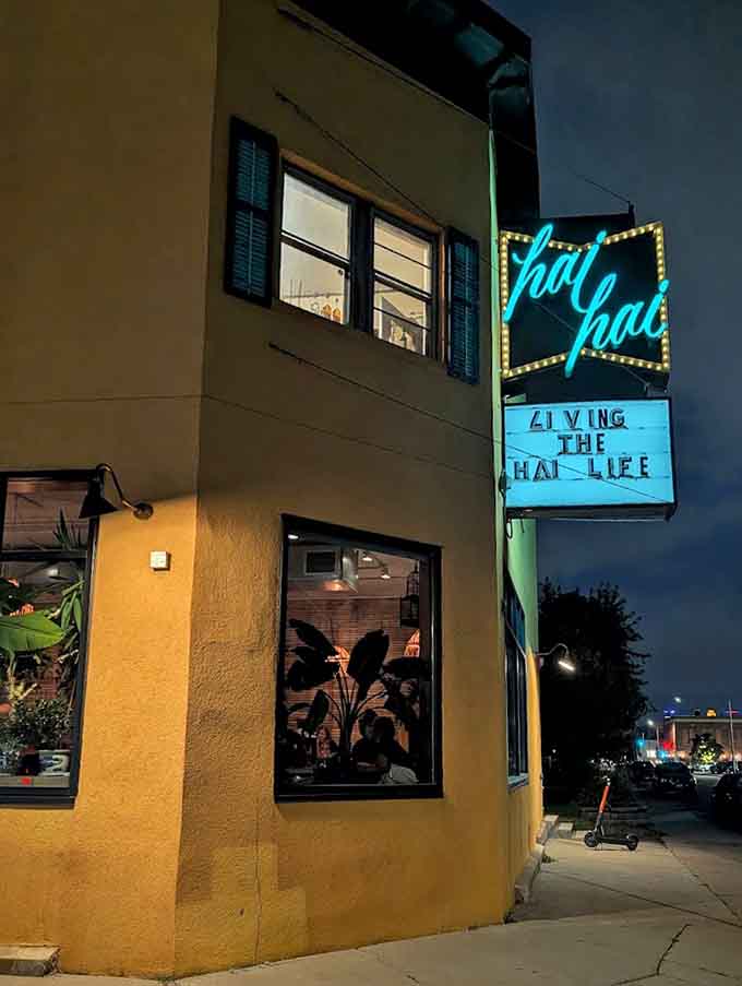 That neon sign glowing against the evening sky acts like a beacon, calling hungry diners to their next great meal adventure.