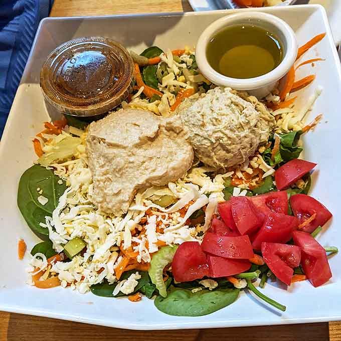 Hummus Salad: A protein-packed power lunch featuring creamy hummus atop fresh greens with colorful vegetables &ndash; proof that salads can be both virtuous and satisfying.