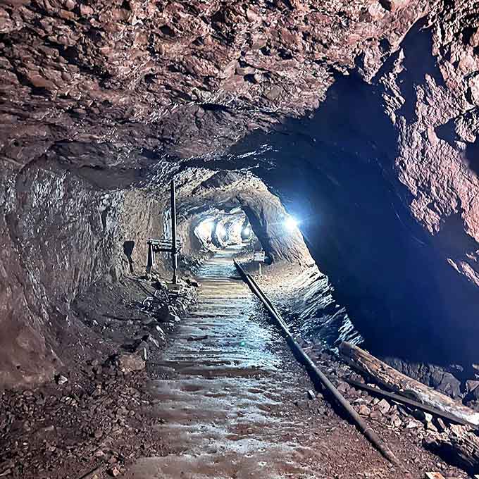 Wooden supports frame tunnels where miners once worked by candlelight, the copper-streaked walls still bearing marks of their tools.