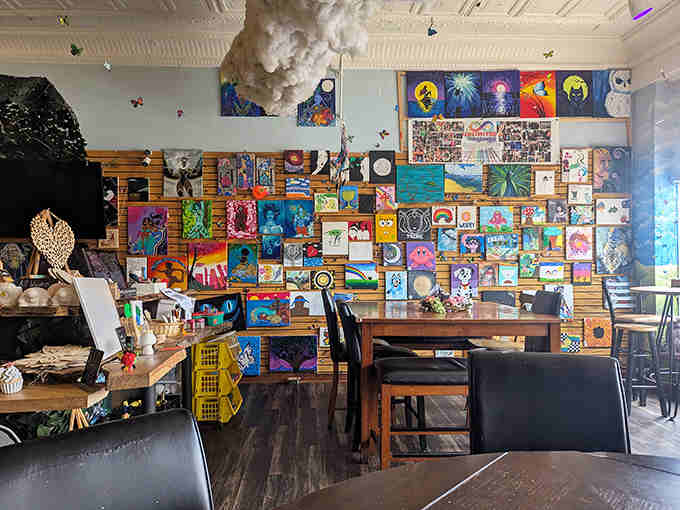 A gallery wall showcases customer creations, turning the cafe into a living museum where art and appetite coexist in colorful harmony.