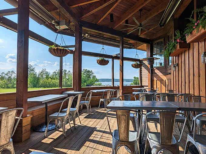 Outdoor seating offers unobstructed river views, where every table feels like the best seat in the house during golden hour.