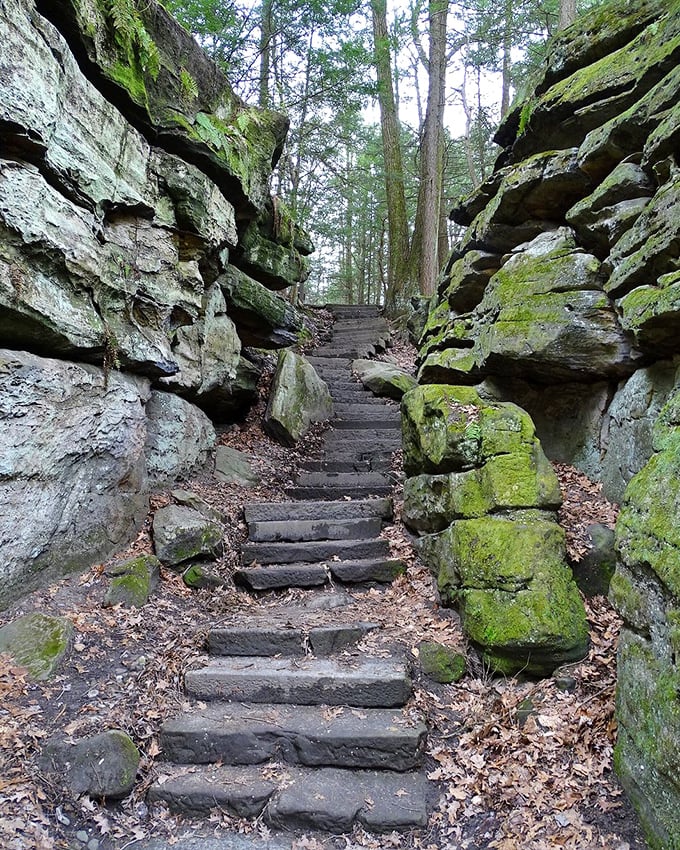 Stone steps carved between massive rock formations invite explorers deeper into this geological wonderland.