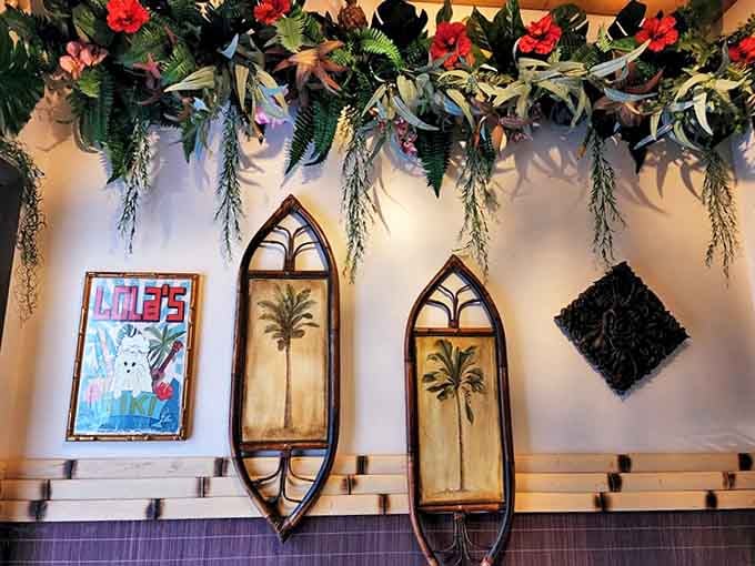 Surfboard-shaped wall art and tropical foliage create a beachy vibe. These thoughtful design touches transport diners from Illinois to a far-flung island paradise.