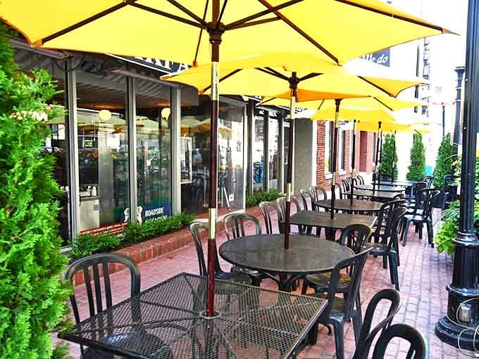 Sunshine-yellow umbrellas create breakfast oases on the sidewalk, perfect for people-watching with your pancakes.