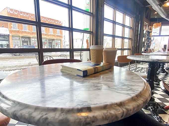 Morning light streams through windows onto marble tables, creating the perfect setting for that "I'm just going to sit here with my coffee and contemplate life" moment.