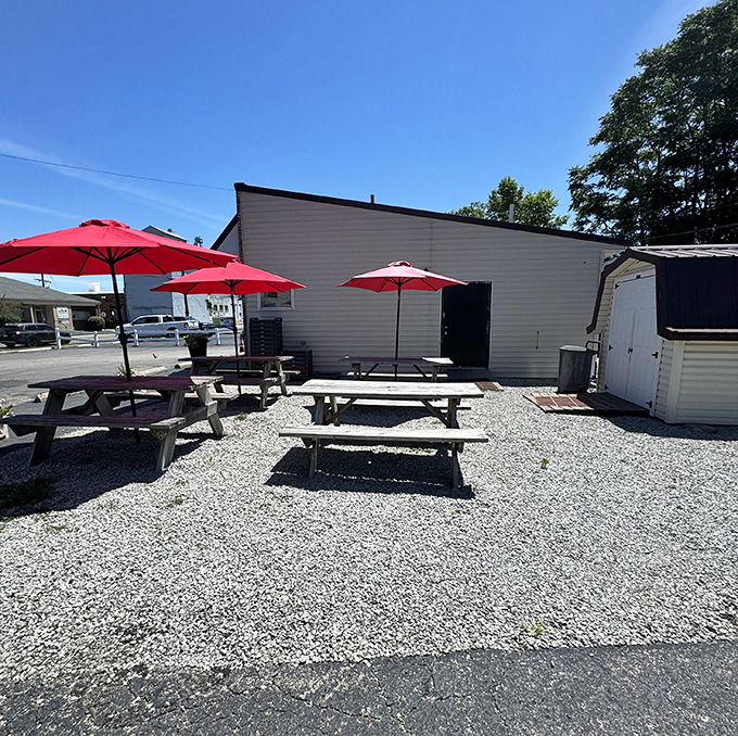 Summer dining done right &ndash; picnic tables under bright red umbrellas make the perfect setting for burger bliss on sunny days.