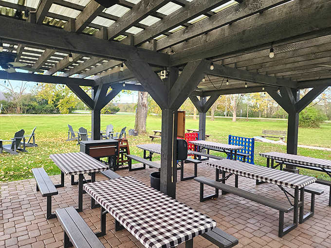 Outdoor seating under a rustic pergola offers a peaceful alternative for enjoying that legendary fried chicken on beautiful Ohio days.