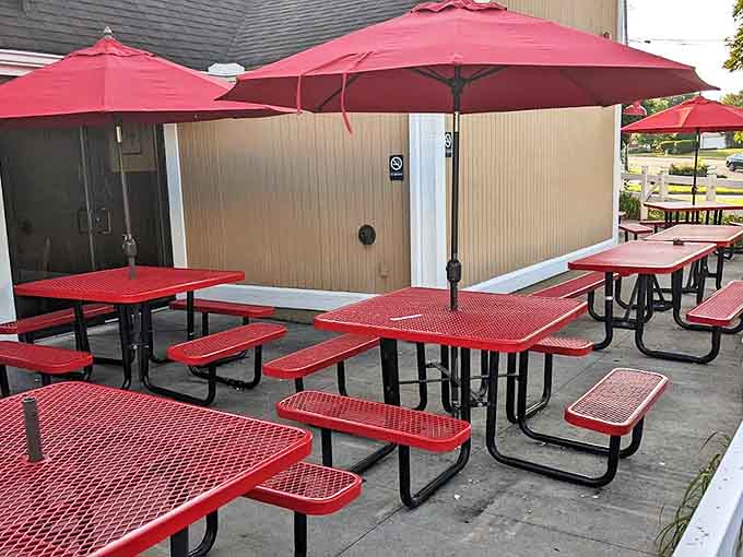 The outdoor seating area offers a more casual dining option, where red picnic tables invite families to enjoy barbecue al fresco.