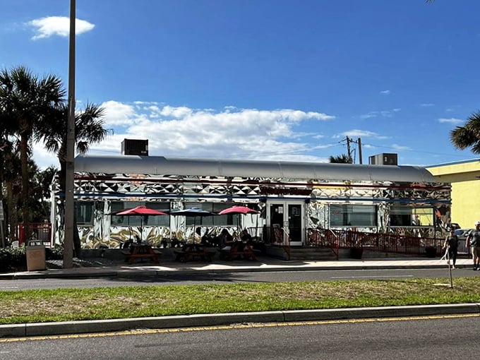 Palm trees frame the diner's shining exterior, a perfect marriage of tropical paradise and classic Americana along Daytona's bustling Atlantic Avenue.