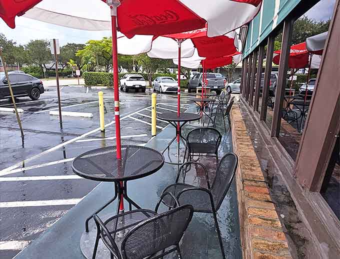 Red and white umbrellas shelter metal tables where diners can enjoy Florida's weather along with their perfectly crafted burgers.