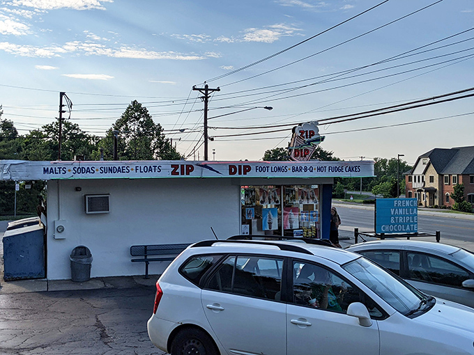 The parking area fills with cars as customers make their pilgrimage to this temple of frozen treats and nostalgic charm.