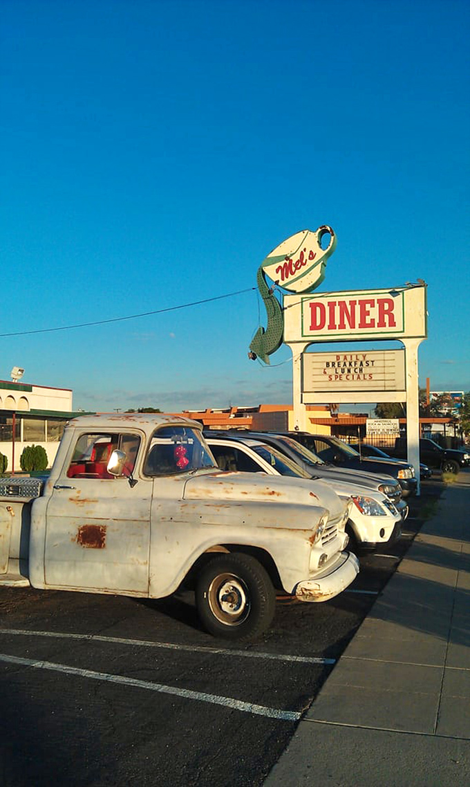 The parking lot where vintage trucks and modern cars coexist, much like the timeless recipes and loyal multi-generational customers inside.