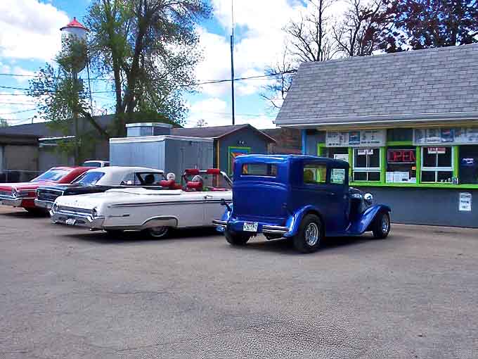 Classic cars find their spiritual home in Ginny's parking lot, where automotive history meets culinary tradition in perfect harmony.