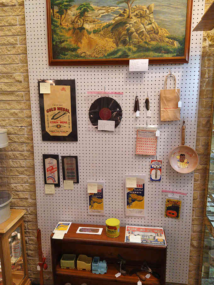 This pegboard wall showcases the everyday items that once filled American homes, from flour sacks to kitchen gadgets that prove our grandparents were pretty clever.