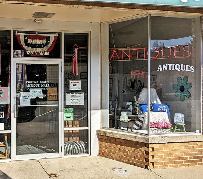 The welcoming doorway to Pinetree Antiques promises adventures in time travel. That patriotic bunting suggests even the building celebrates American history.