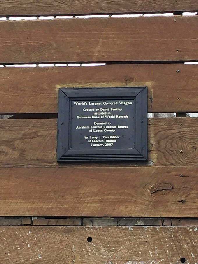 The official plaque details the wagon's journey from creation by David Bentley to its permanent home in Lincoln, Illinois.