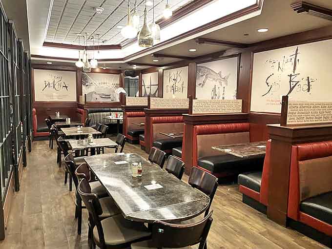 Red booths invite lingering conversations over coffee and dessert, where comfort meets style in Hell's Kitchen's thoughtfully designed space.