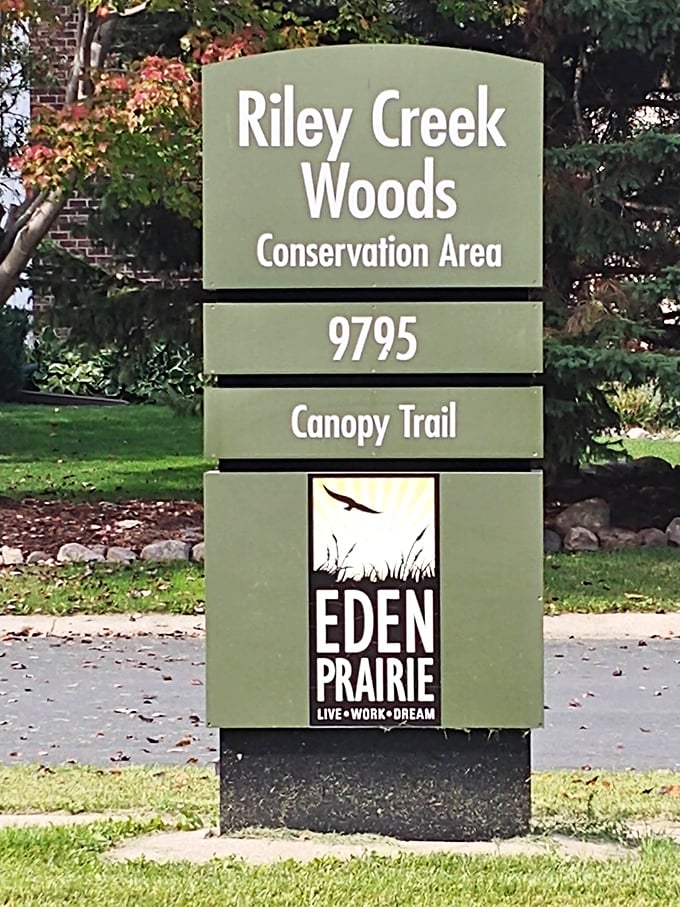 The welcoming entrance sign to Riley Creek Woods Conservation Area, part of Eden Prairie's commitment to preserving natural spaces.