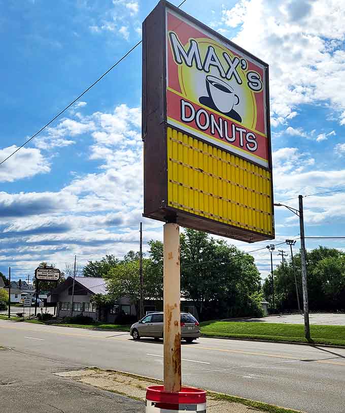 Road Signage: The beacon that guides hungry travelers to donut nirvana, standing tall against Michigan's big blue sky.