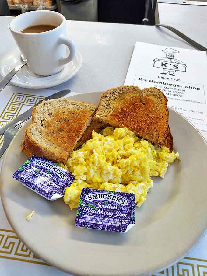 Breakfast of champions: perfectly scrambled eggs, toast with the ideal golden-brown hue, and those little jam packets that always make you feel special.