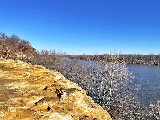 Nature's infinity pool – the sandstone edge frames the Illinois River's meandering path, creating postcard-worthy views in every season.