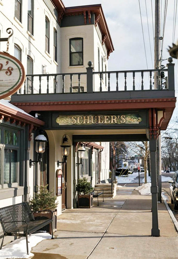 The welcoming entrance with its classic signage promises an experience that begins the moment you step under the awning.