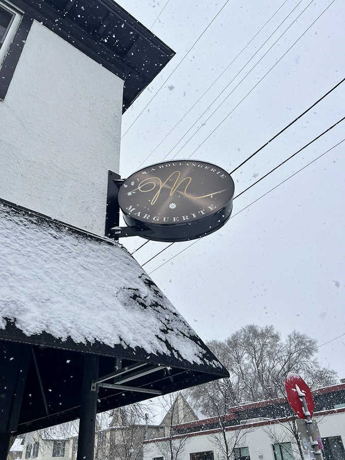 Even in snowy weather, Marguerite's sign promises warmth and comfort inside, like a buttery lighthouse guiding hungry sailors home.