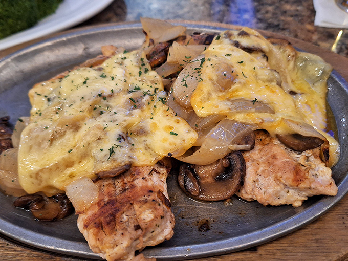 Smothered Chicken: Proof that chicken doesn't have to be boring&mdash;especially when buried under a avalanche of mushrooms, onions, and melted cheese.