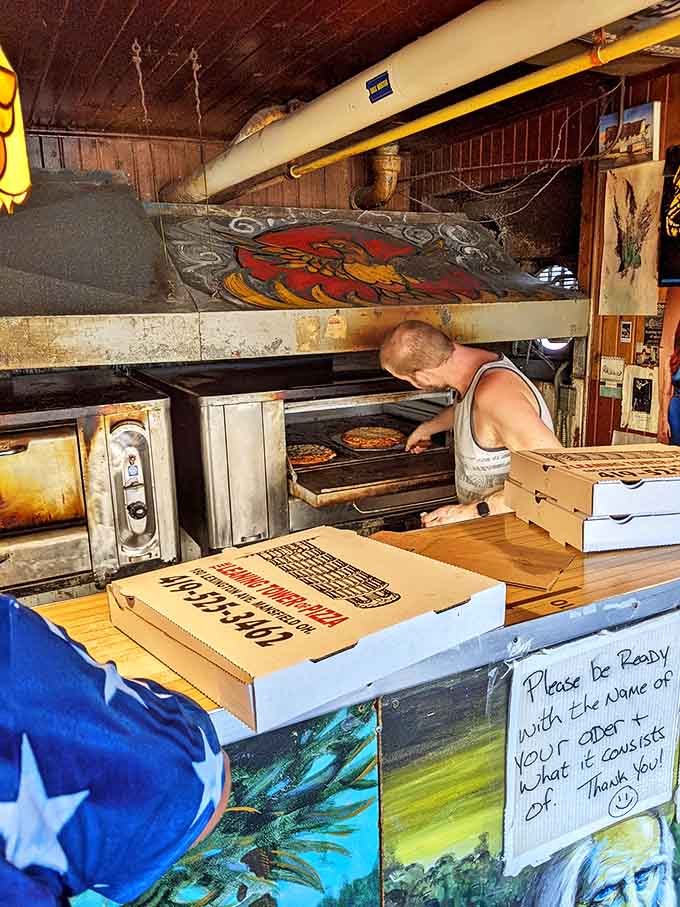 Behind the scenes magic: watching skilled hands prepare pizzas in well-seasoned ovens that have produced thousands of perfect pies.