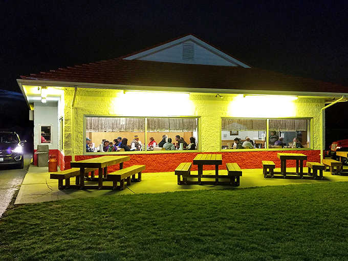 At night, Bill's glows like a barbecue beacon, its windows illuminating the darkness with promises of smoky delights within.