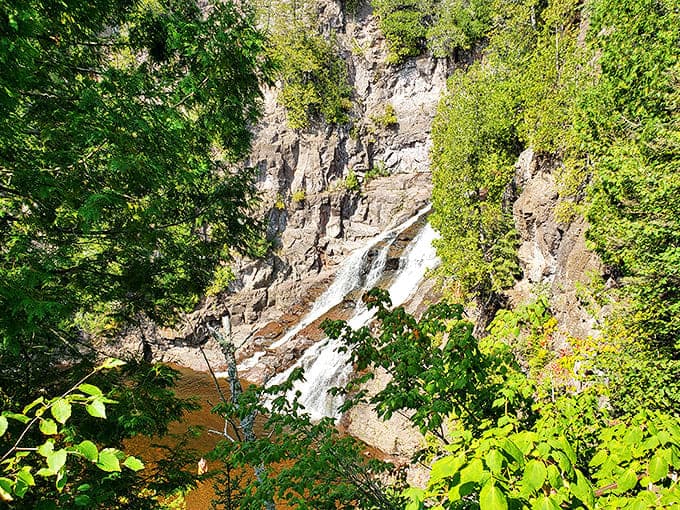 Caribou Falls in full sunlight becomes a dazzling display of power and grace. The waterfall performs its timeless dance between rugged cliff walls.