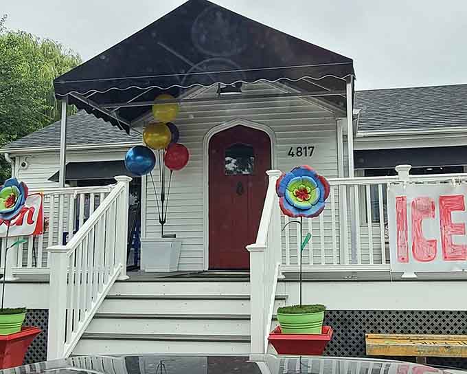 The welcoming porch, with its cheerful "Open" sign and giant gumball machine, serves as the gateway to cookie paradise.