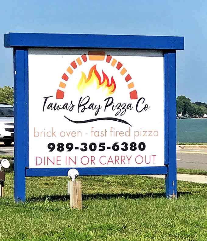 This isn't just a sign &ndash; it's a beacon of hope for hungry travelers seeking brick oven salvation along Michigan's scenic shoreline.
