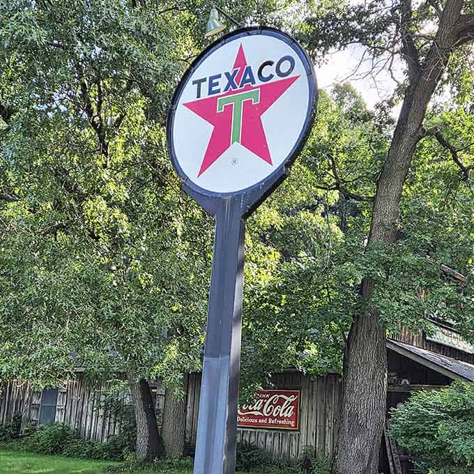 The iconic Texaco star sign rises above the trees, a beacon guiding collectors and nostalgia-seekers to this hidden trove of Americana.