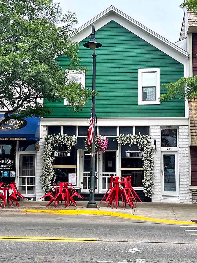 The green and white exterior stands proudly on Bridge Street, with flower garlands framing the entrance like nature's own welcome sign.