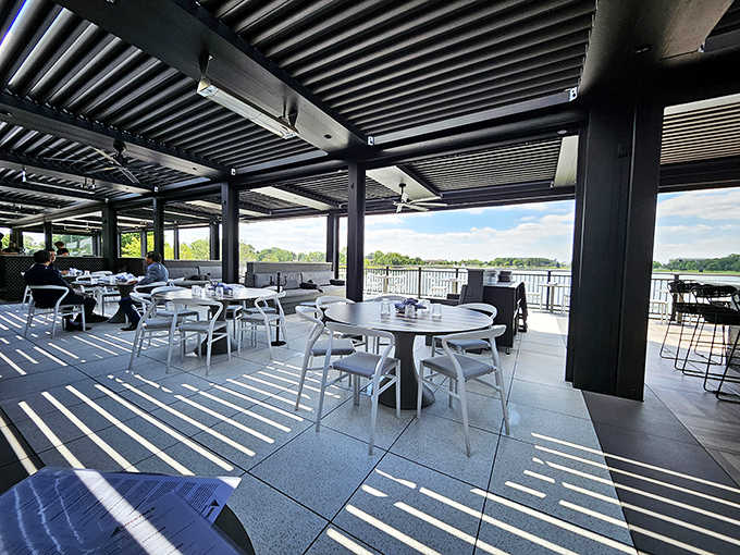 The covered patio provides protection from the elements while maintaining the connection to nature, perfect for dining in changing Midwest weather.