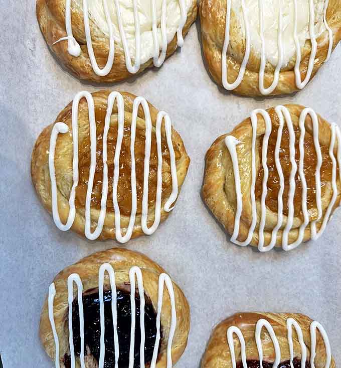 Danish pastries with their golden layers and sweet fillings, waiting patiently to shatter into buttery shards at first bite.