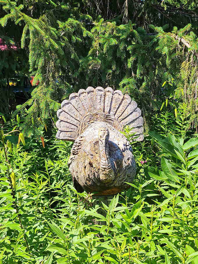 The turkey statue stands guard in the garden, a quirky sentinel reminding visitors exactly what put this place on the culinary map.