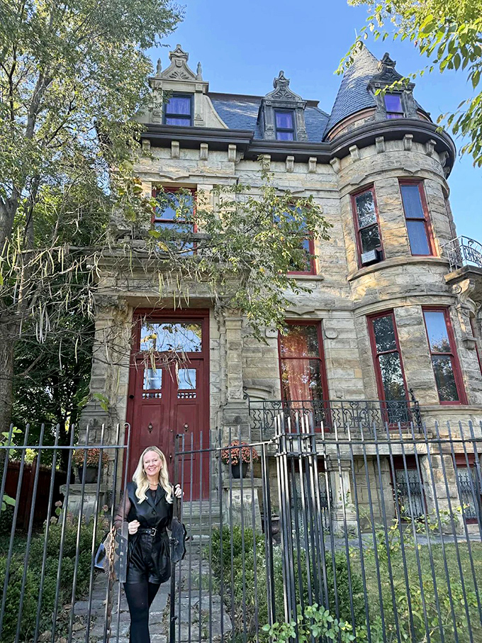 Visitors pose before the iron gates, capturing their moment with Cleveland's Gothic masterpiece, proof they've seen something truly extraordinary.