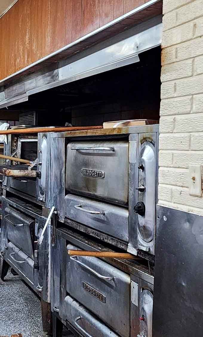 The kitchen's well-seasoned ovens have been turning out perfect pizzas for decades, operated by staff who treat recipes like family heirlooms.