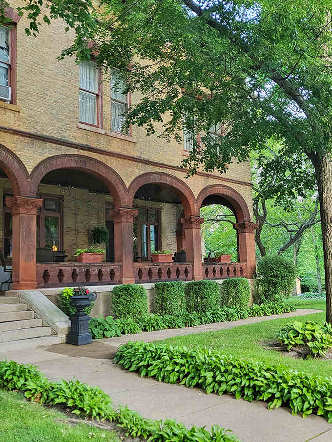 Lush greenery creates a natural frame for the mansion, proving that even the garden knows how to dress appropriately for this grand dame.